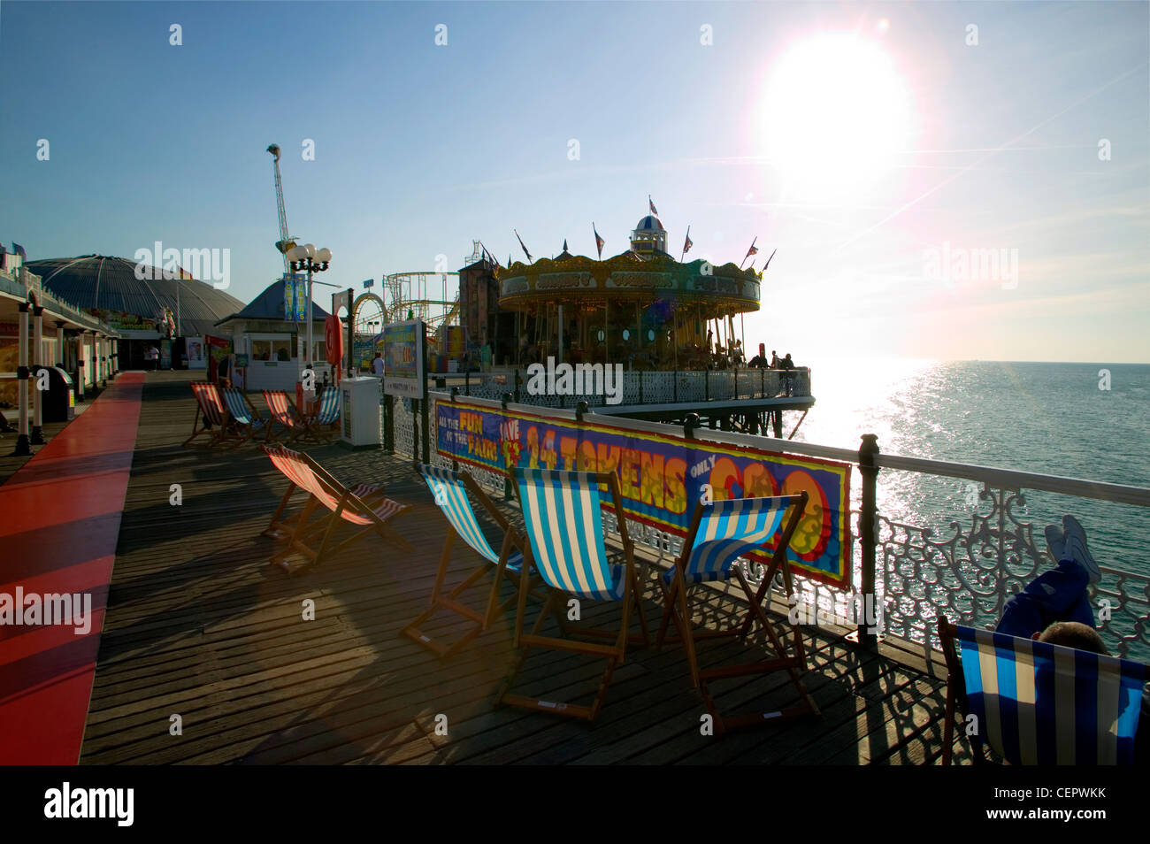 Deckchairs and the funfair on Brighton Pier Stock Photo - Alamy