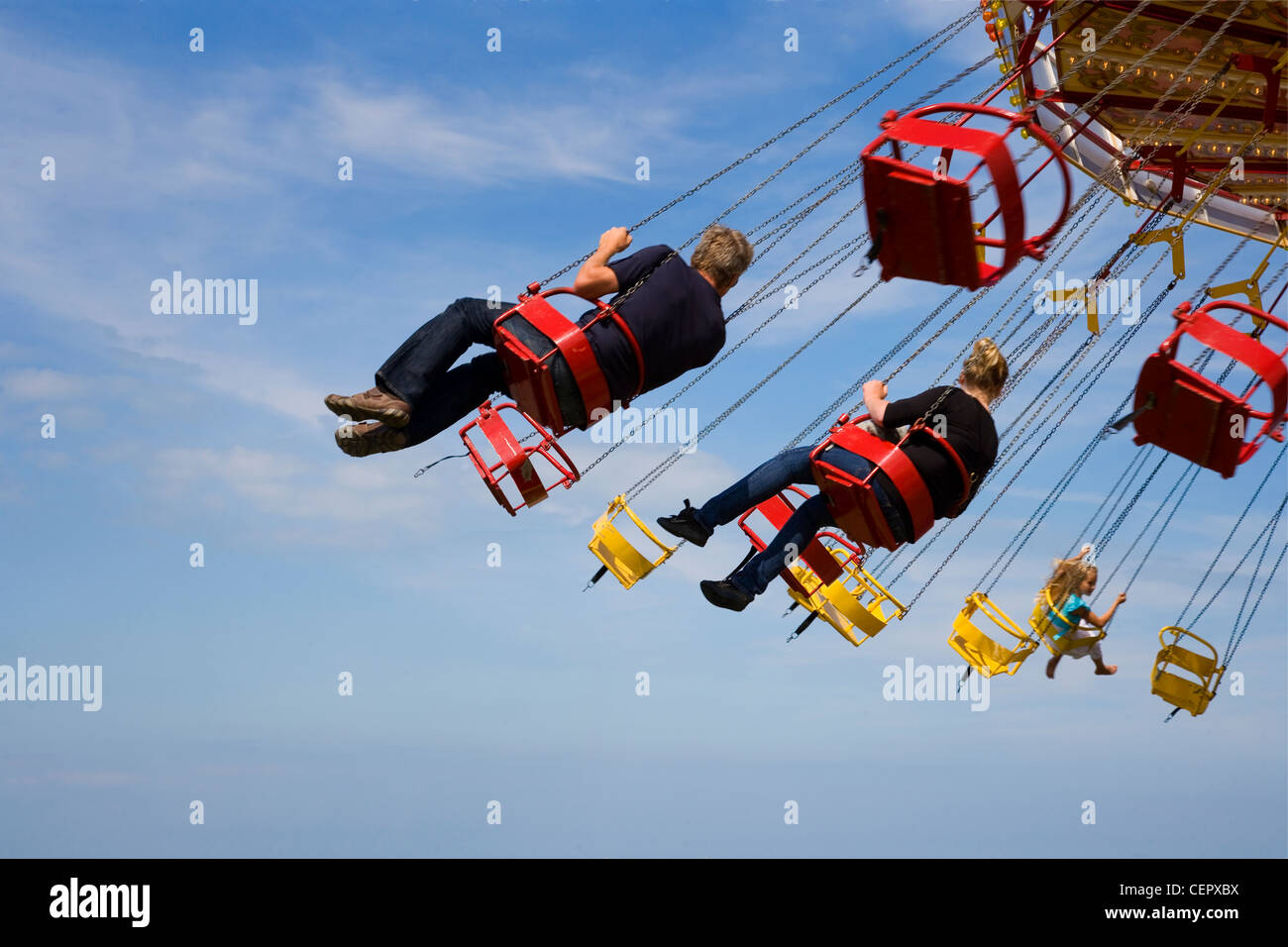 People enjoying a ride on a traditional Chair-o-plane carousel at a ...