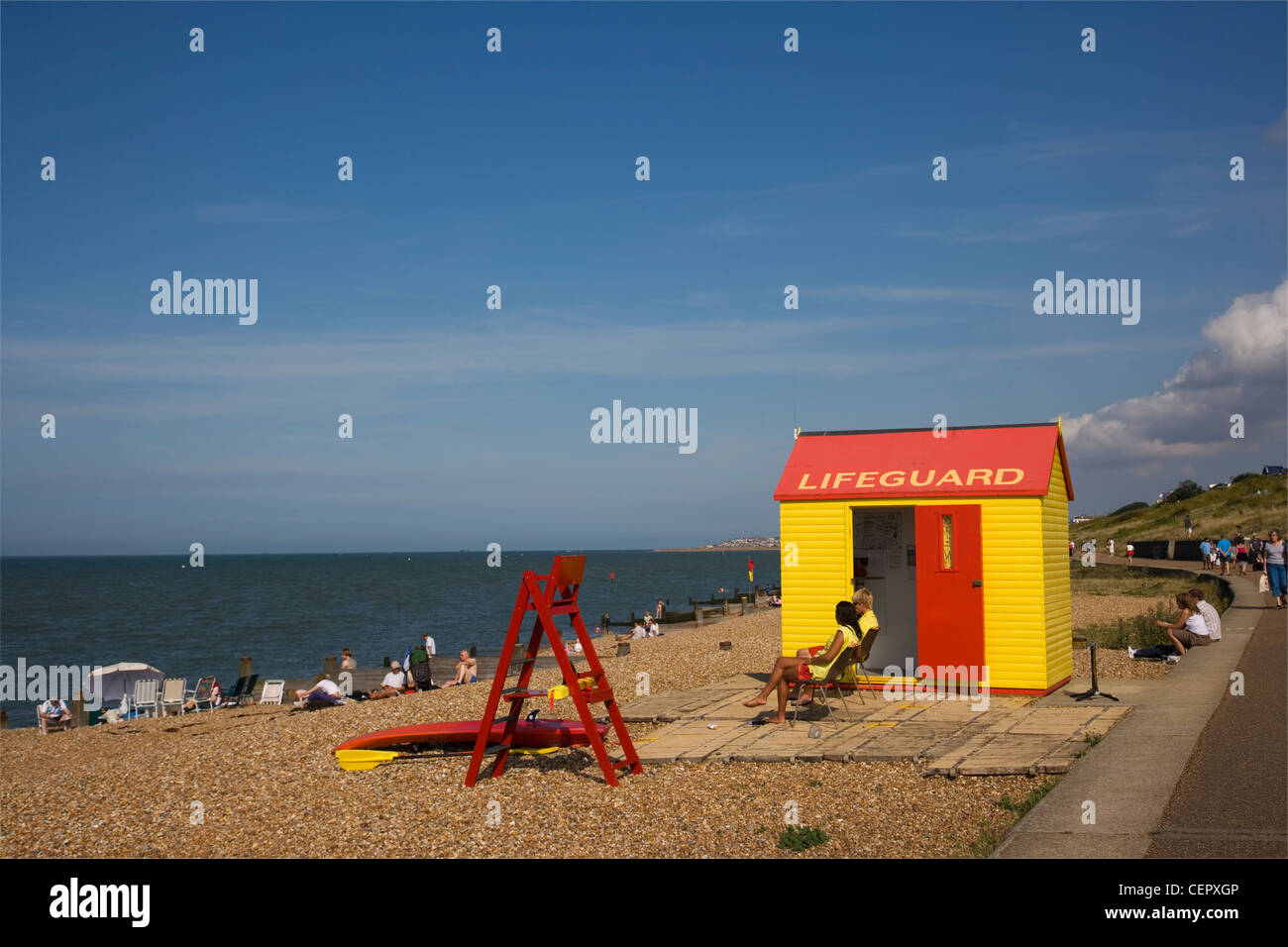 Two lifeguards sitting on duty outside their hut on the beach at ...