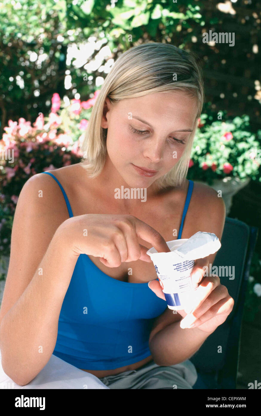 Tanned Female Chin Length Blonde Hair Wearing Subtle Make Up Blue Vest