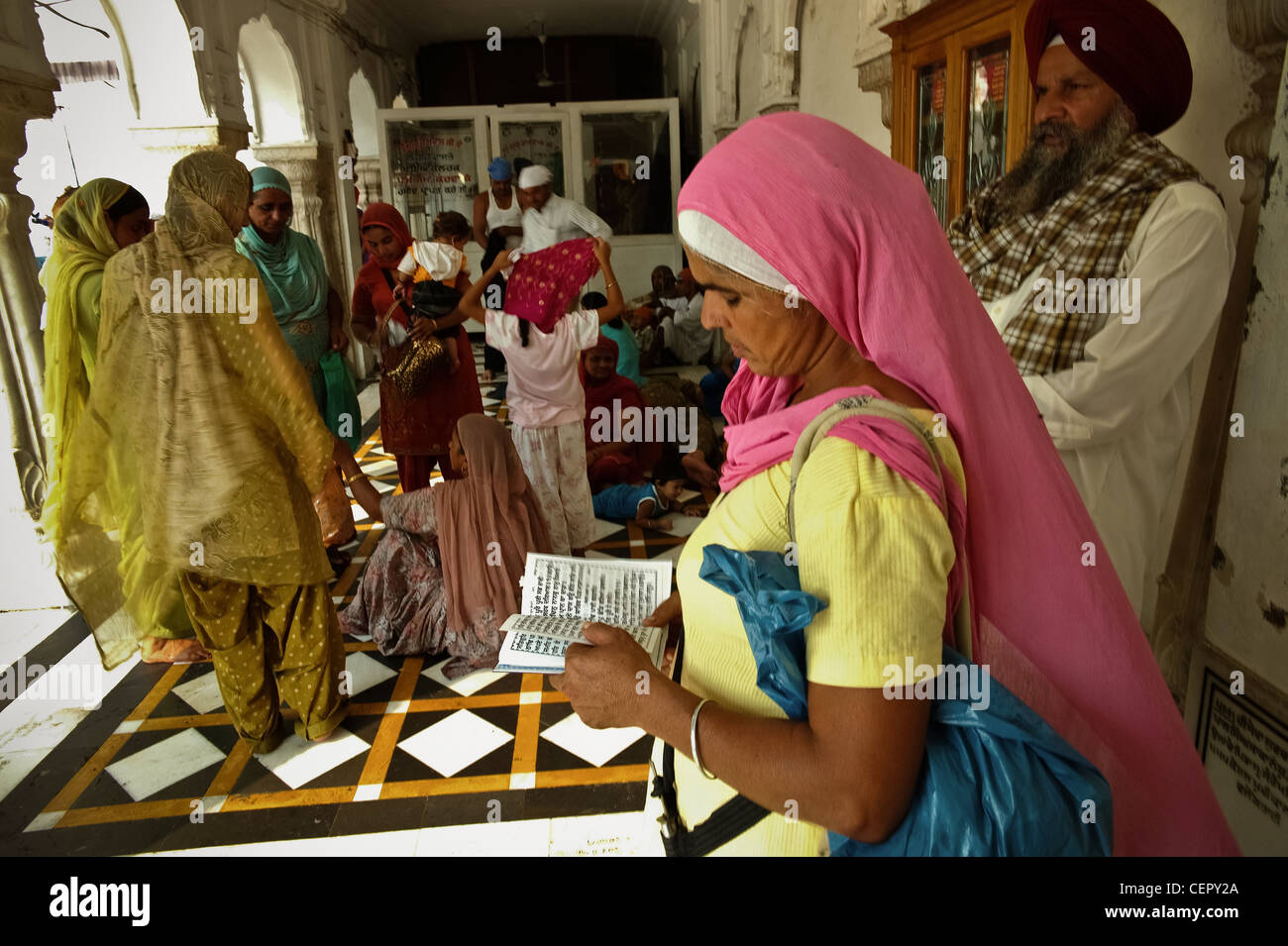 Amritsar , The Sikh Golden Temple, reading a book sacred Stock Photo ...