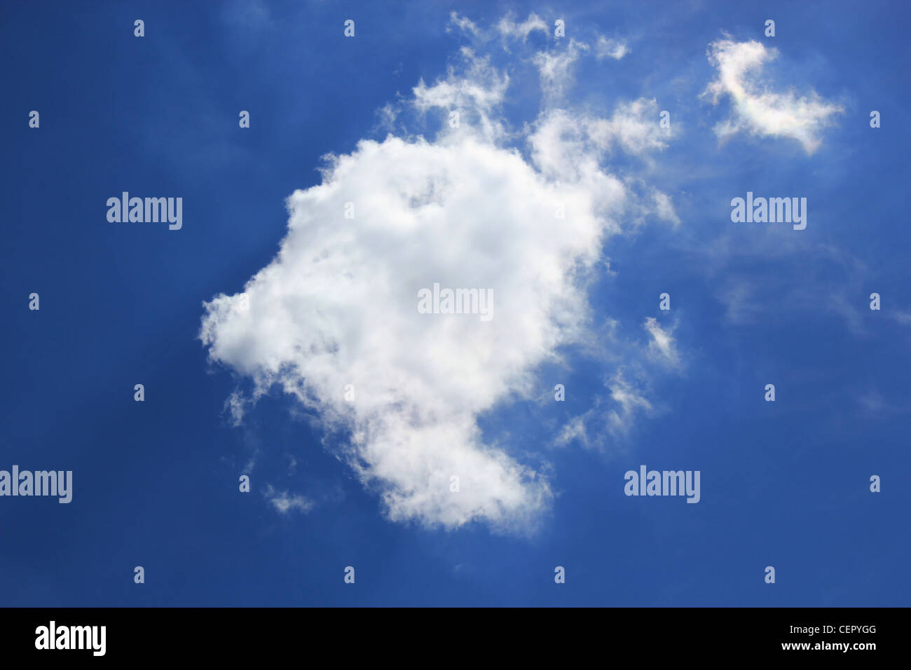 Small white cloud in a deep blue sky Stock Photo - Alamy