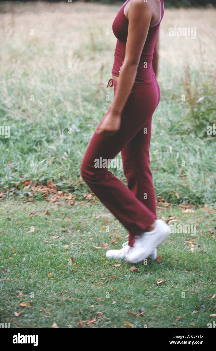 Cropped profile of female wearing dark red vest top dark red tracksuit ...