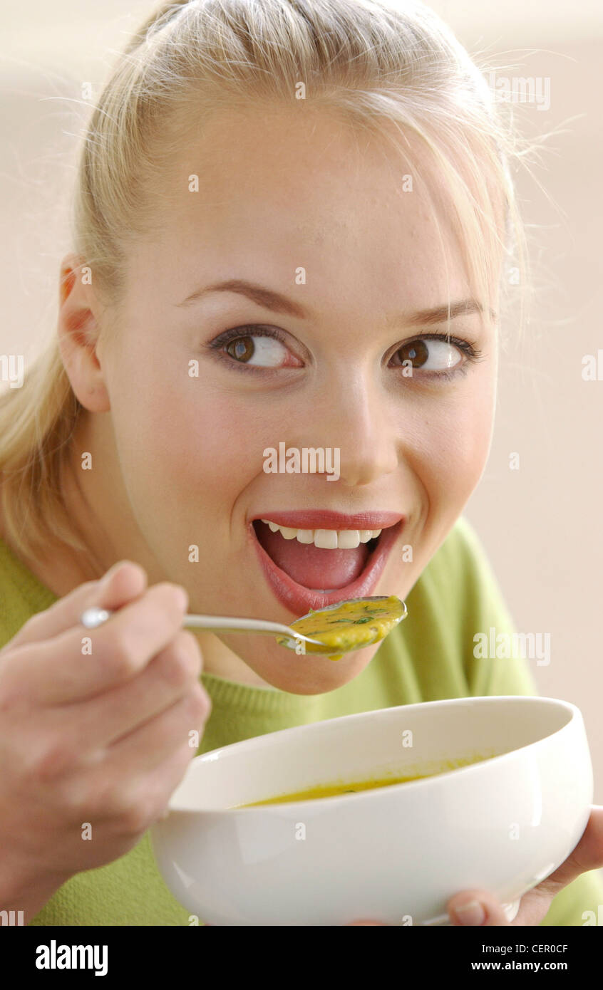 Female blonde hair up strands of fringe over forehead wearing olive ...