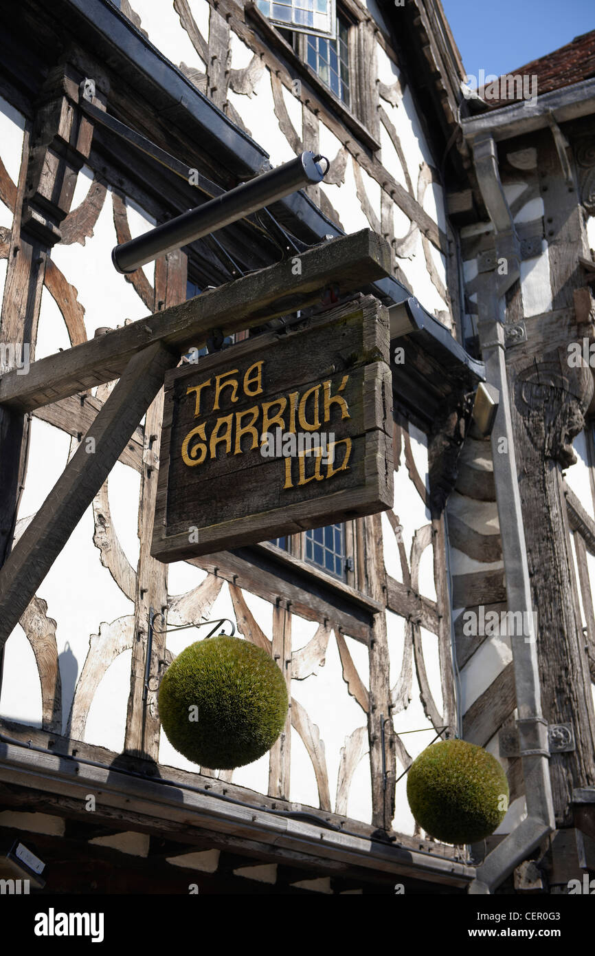 Wooden signage hanging outside The Garrick Inn, a traditional black and ...