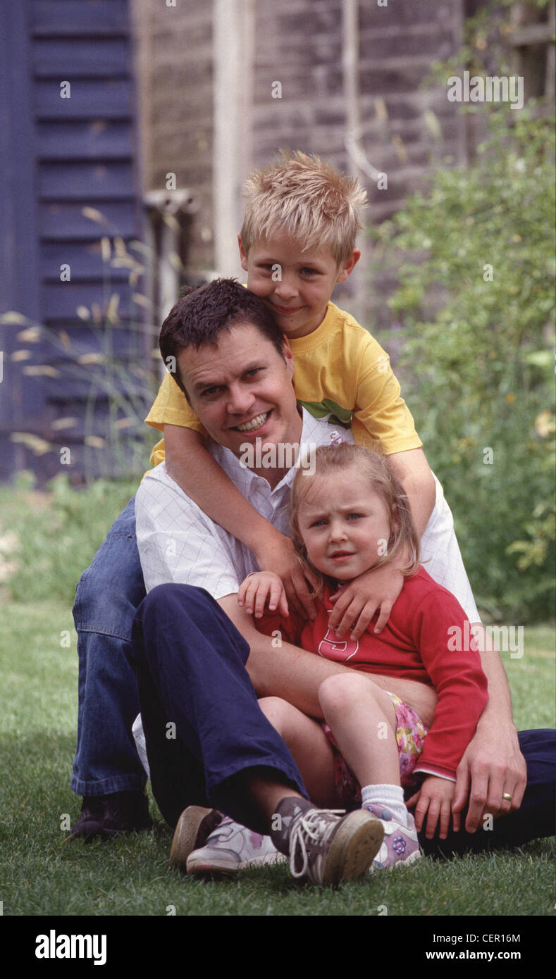 Father short brown hair sitting on grass male child spiky blonde hair ...