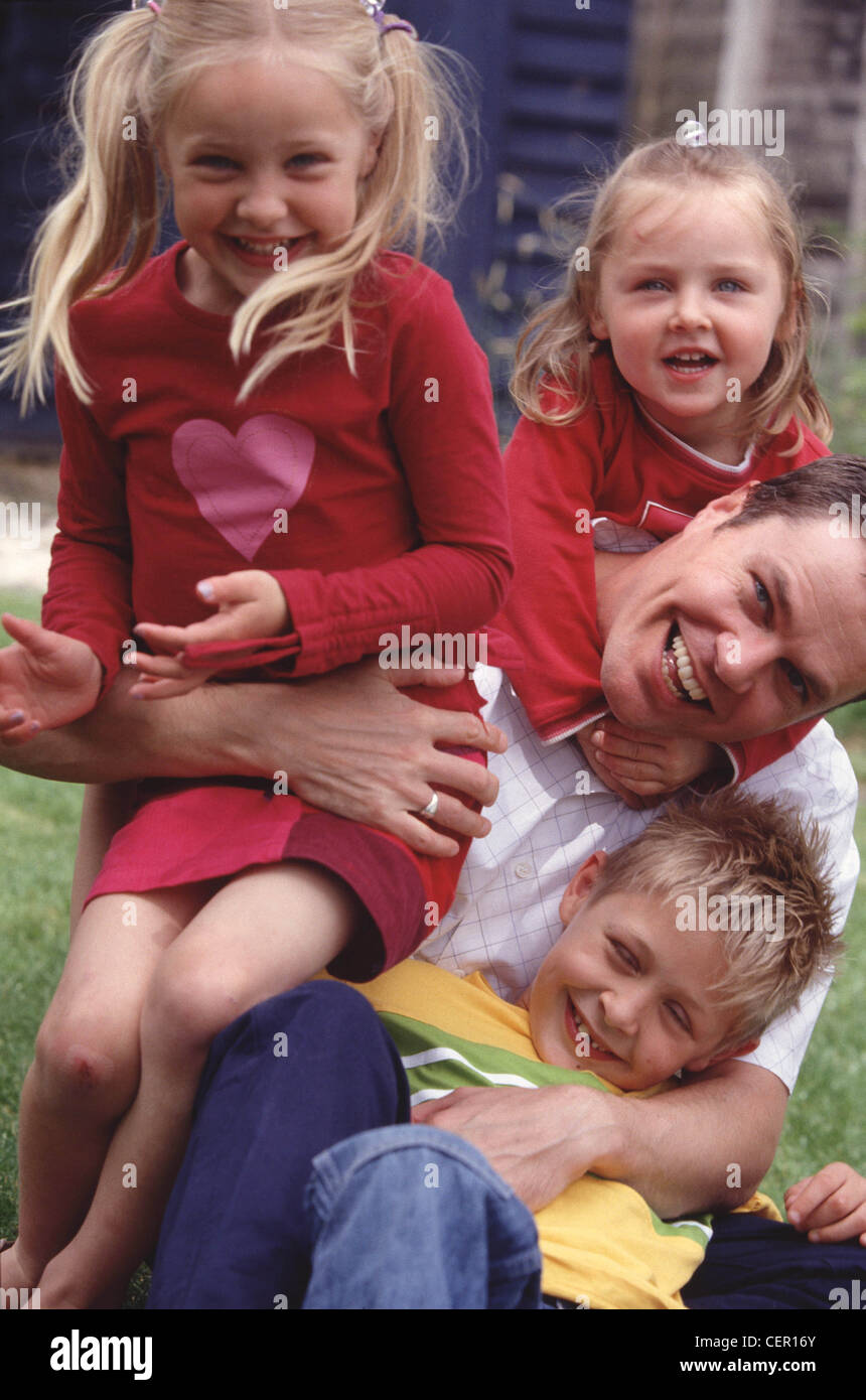 Father short brown hair male child spiky blonde hair two female ...