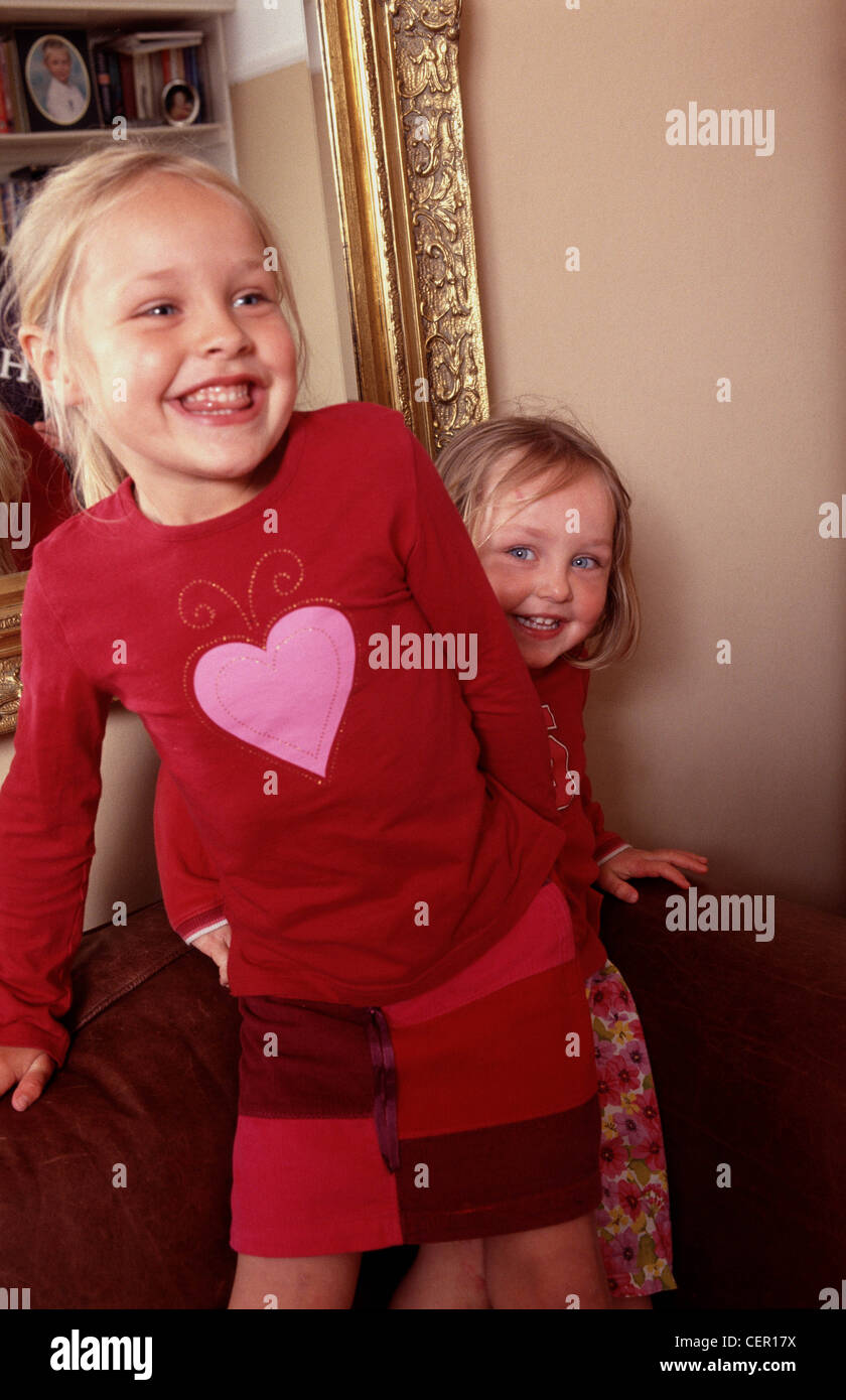 Two female children wearing red top heart and patchwork skirt and ...