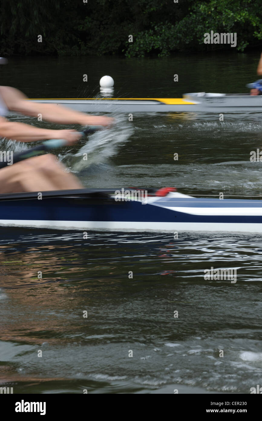 Water splashing up from oars as a boat is powered through the water ...