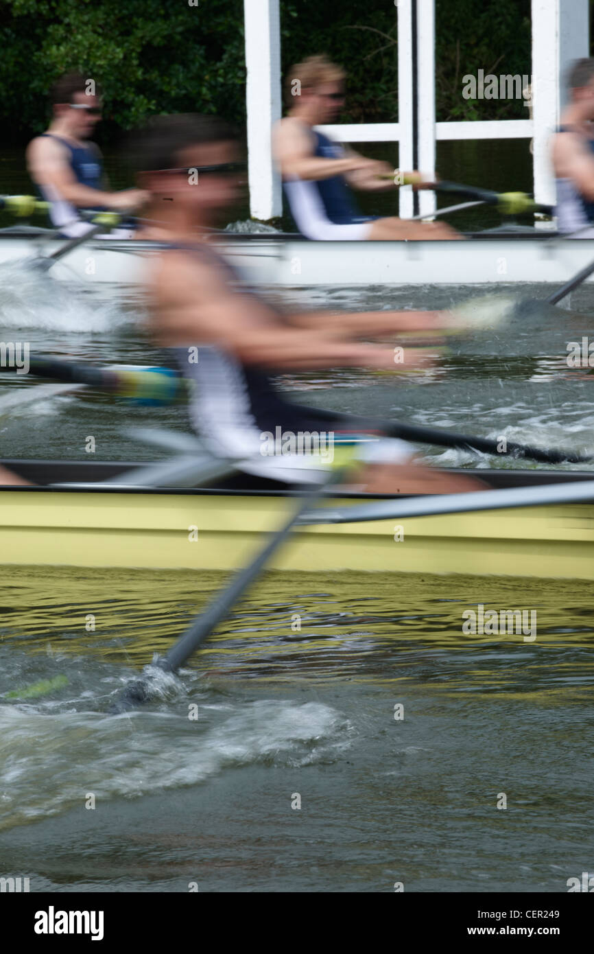 Boat crews rowing powerfully off the start line during a race at the ...