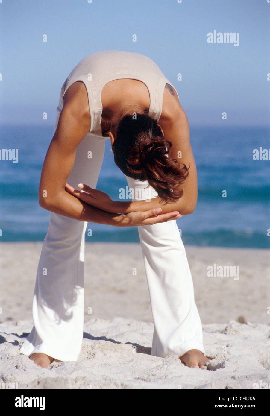 Female wavy brunette hair off face wearing beige vest top and white ...