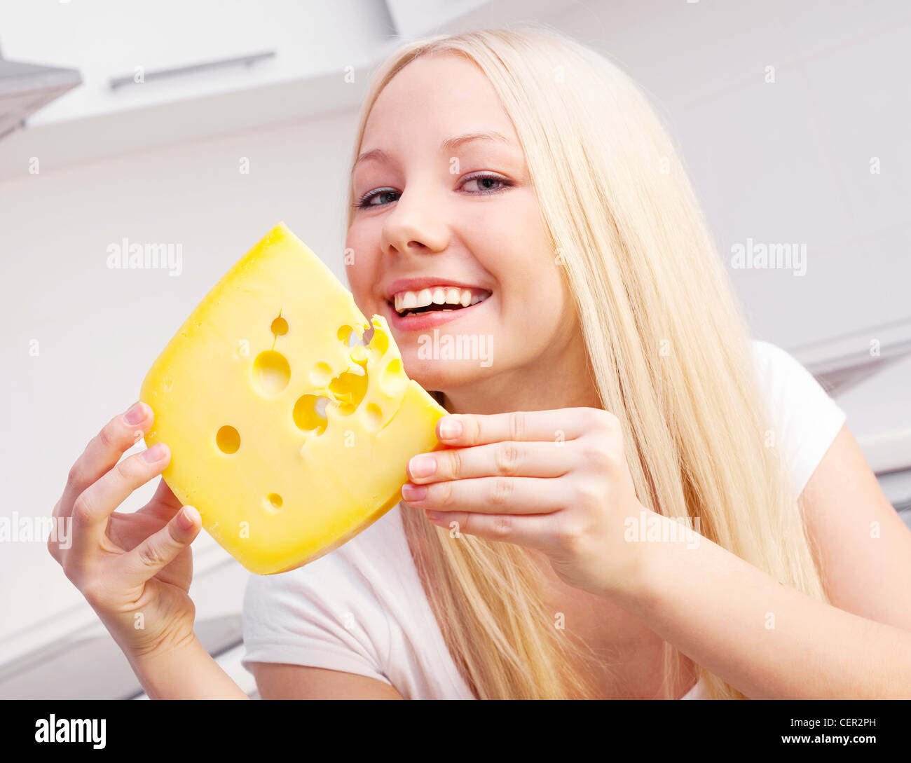 happy woman with cheese in the kitchen at home Stock Photo - Alamy