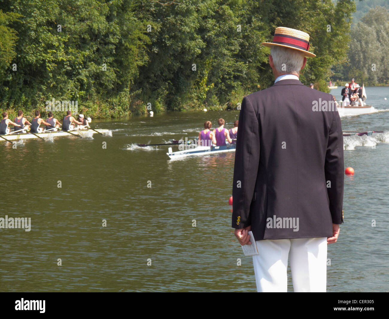 A race referee watching a race speed past during the annual Henley ...