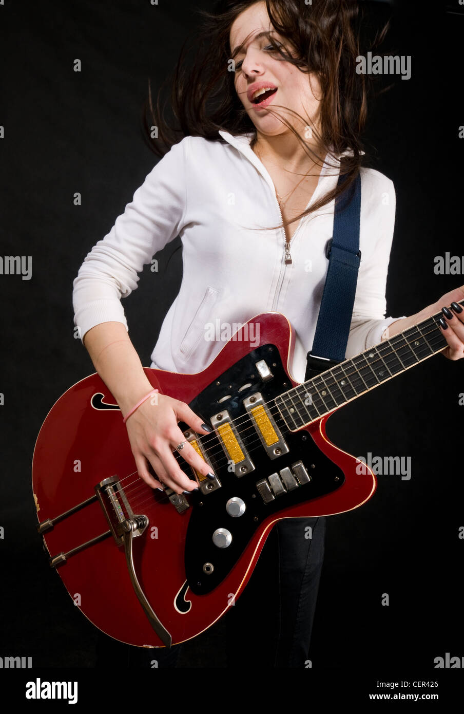 Girl performing on a guitar Stock Photo - Alamy