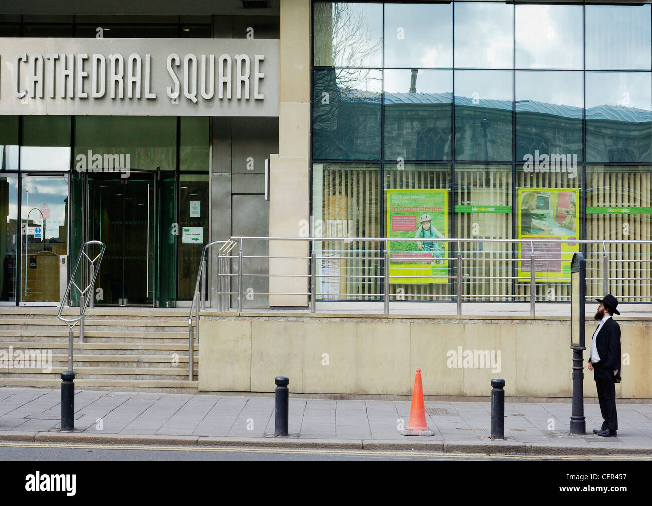 A Jewish man standing at Cathedral Square looking up at a street map ...