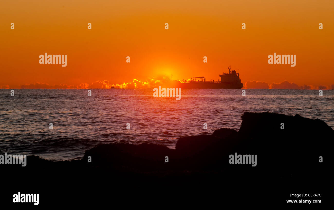 ship on ocean at sunrise Stock Photo - Alamy