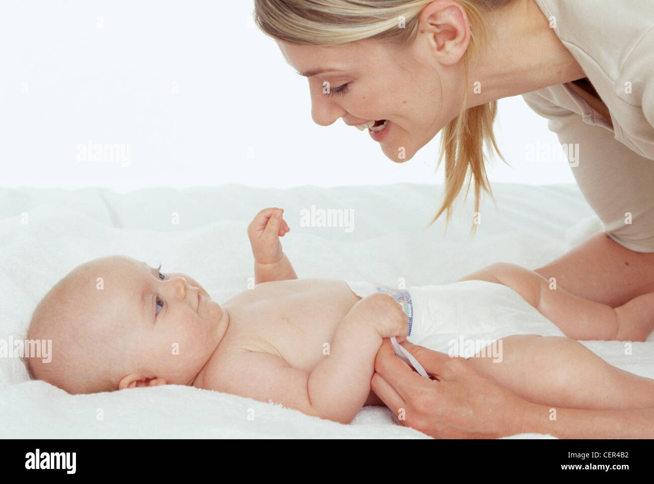 Step by step changing nappy Female blonde hair off face wearing beige ...