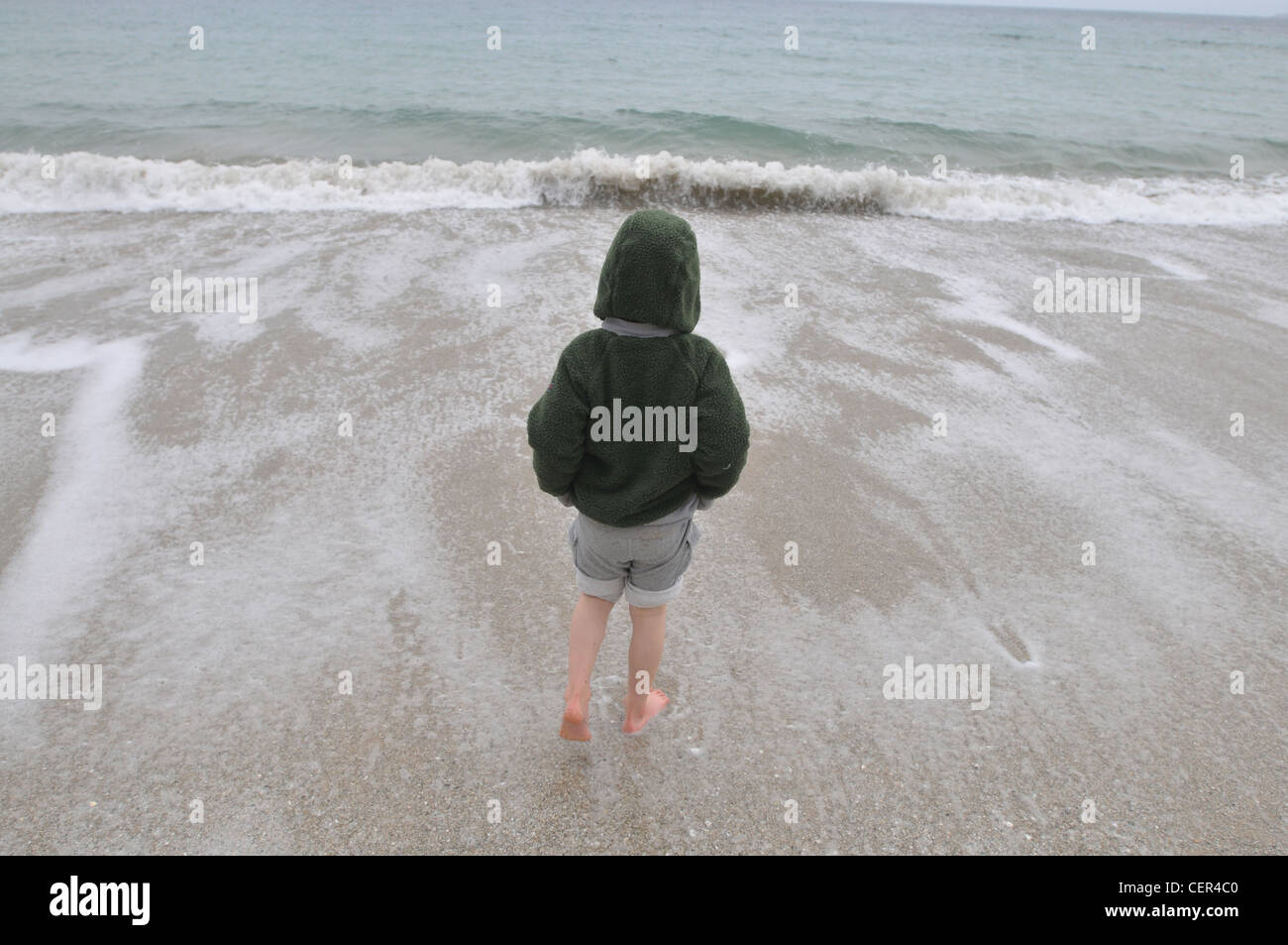 Boy looking out to sea Stock Photo - Alamy