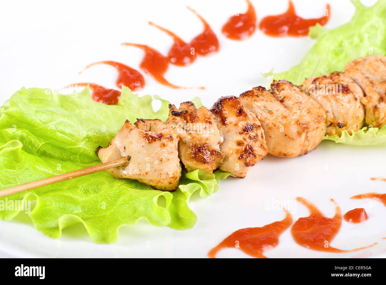 Grilled chicken meat closeup and vegetables isolated on a white ...