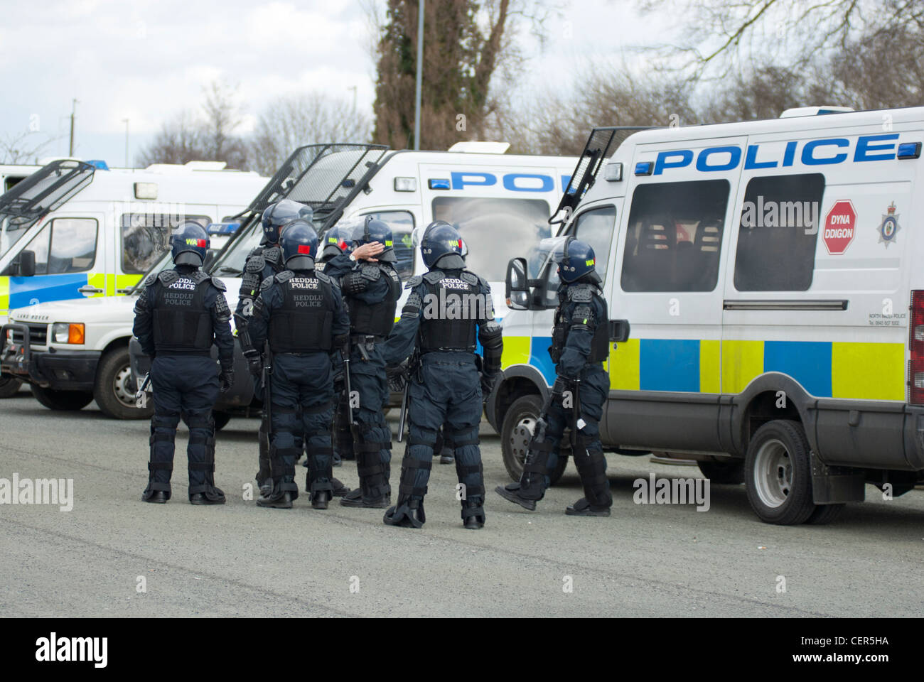 Uk riot police at the scene of a civil disturbance dressed in riot gear ...
