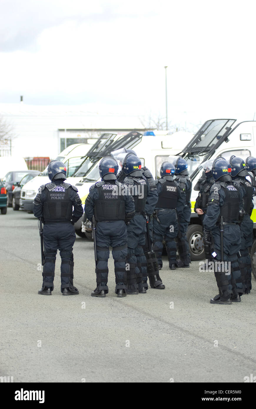 Uk riot police at the scene of a civil disturbance dressed in riot gear ...