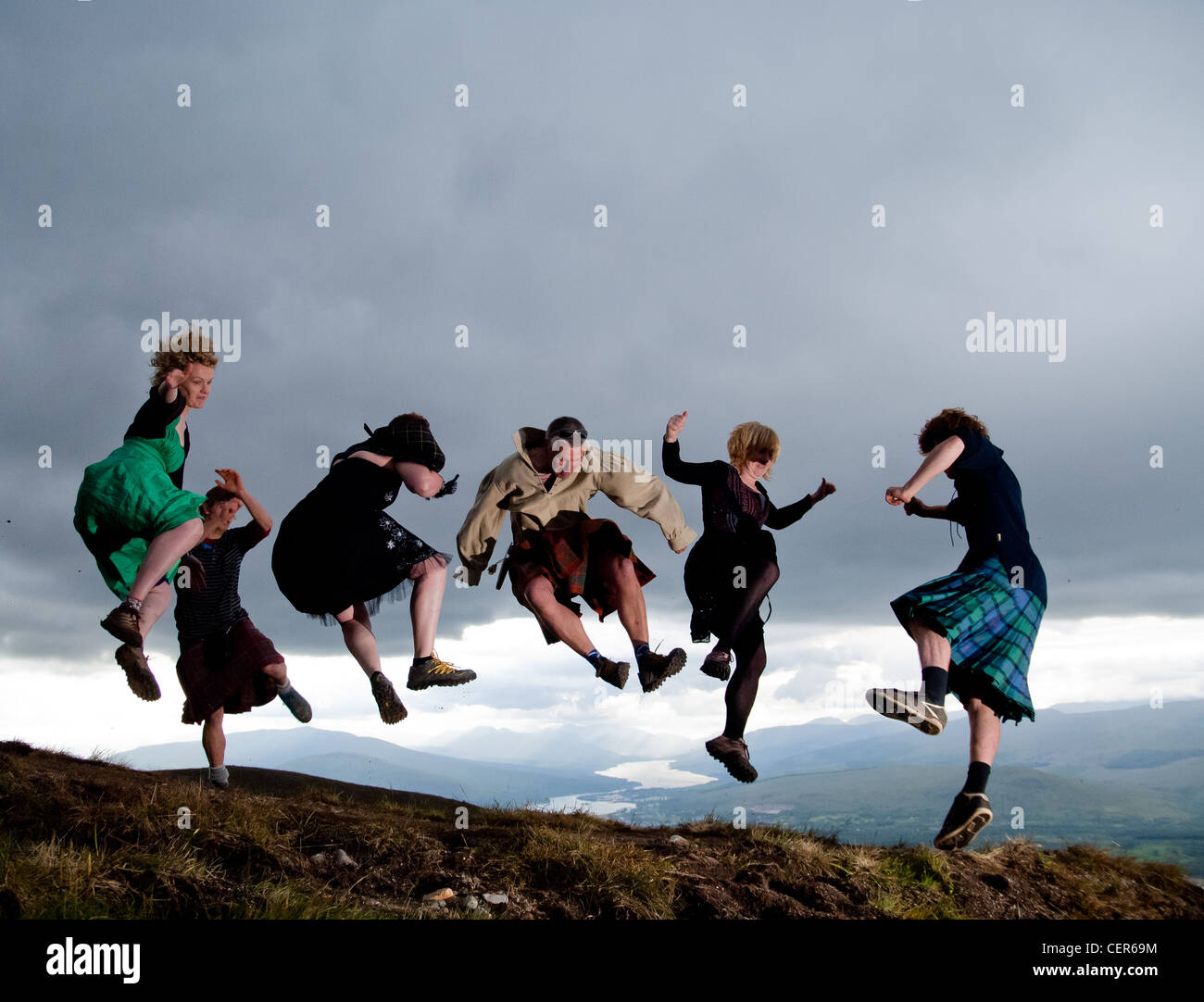 Group celebrating summer solstice by jumping and dancing in the air at ...