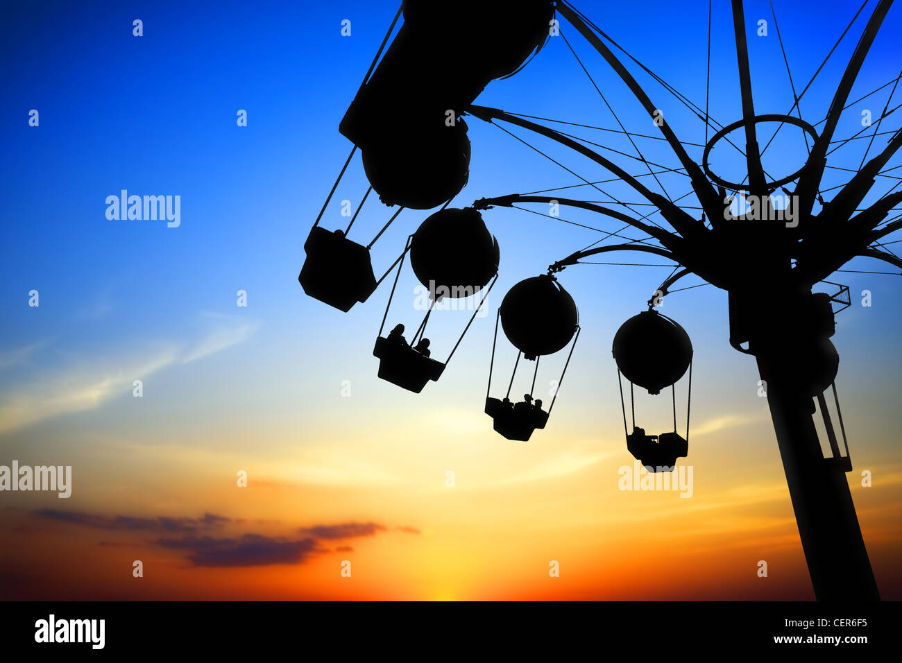 Amusement park at sunset Stock Photo - Alamy