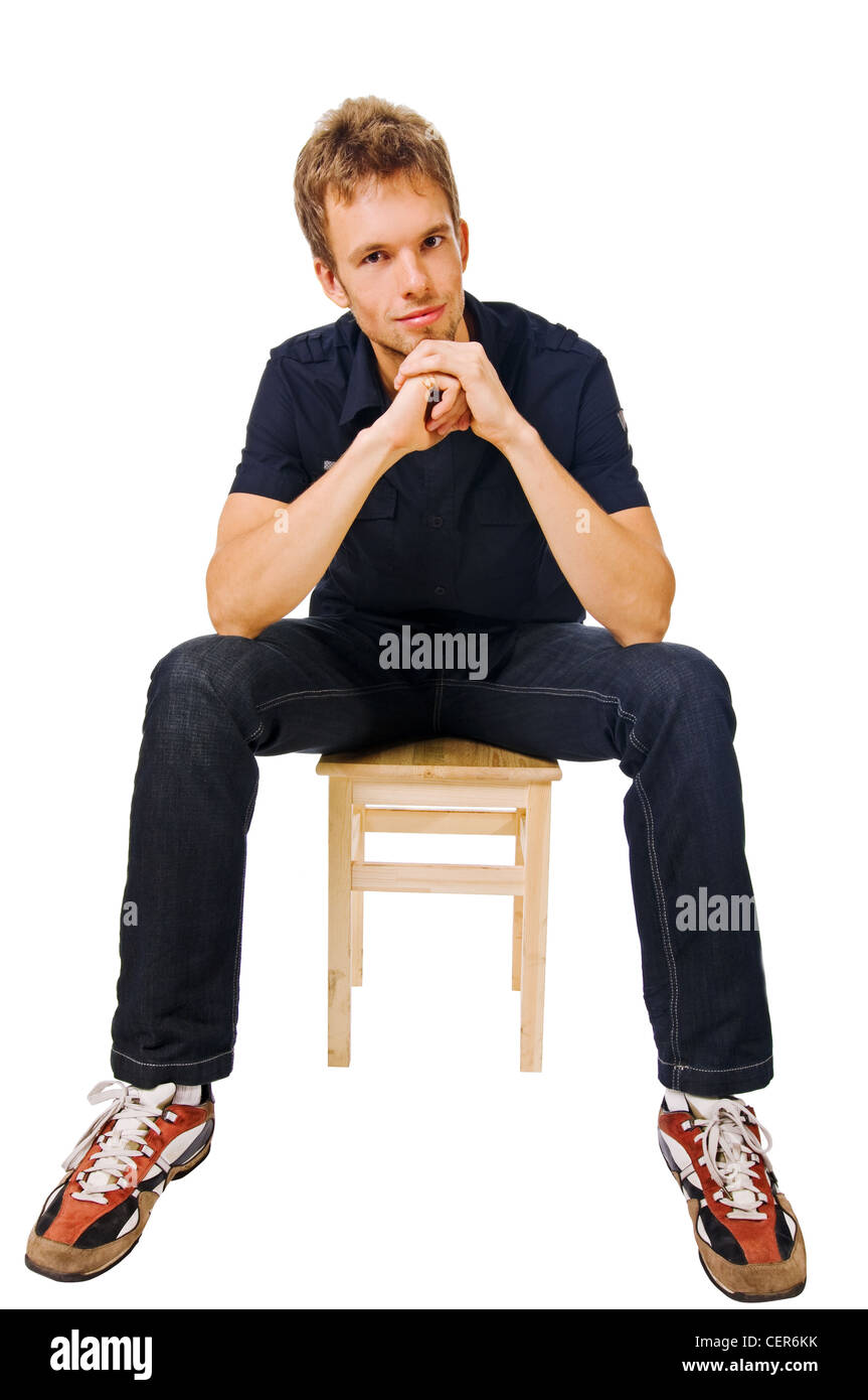 Fit young man sitting isolated on white Stock Photo - Alamy