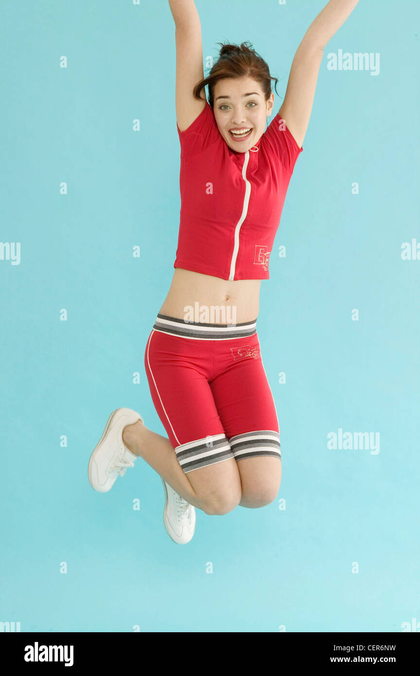 Female brunette hair off face wearing short sleeved red zip top, red ...