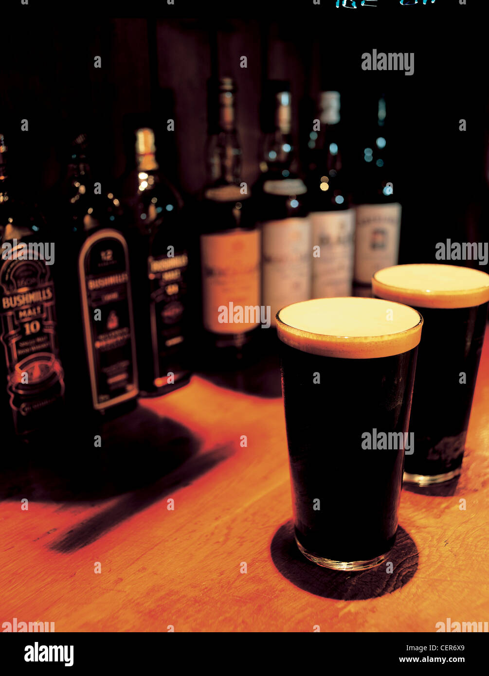 Two pints of Guinness on a bar Stock Photo - Alamy