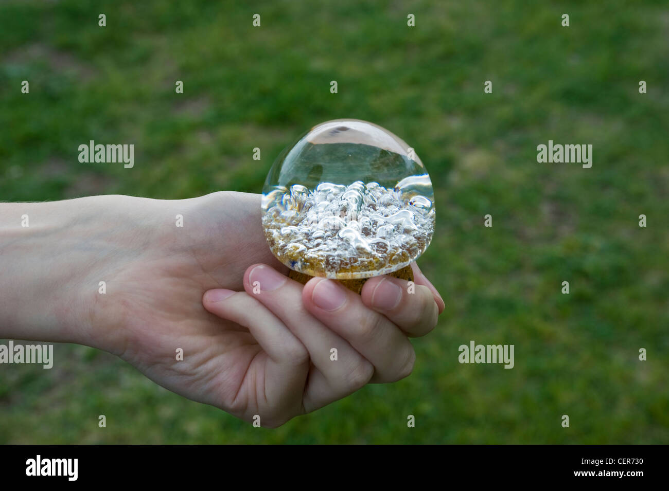 A glass ball held in the hand Stock Photo - Alamy