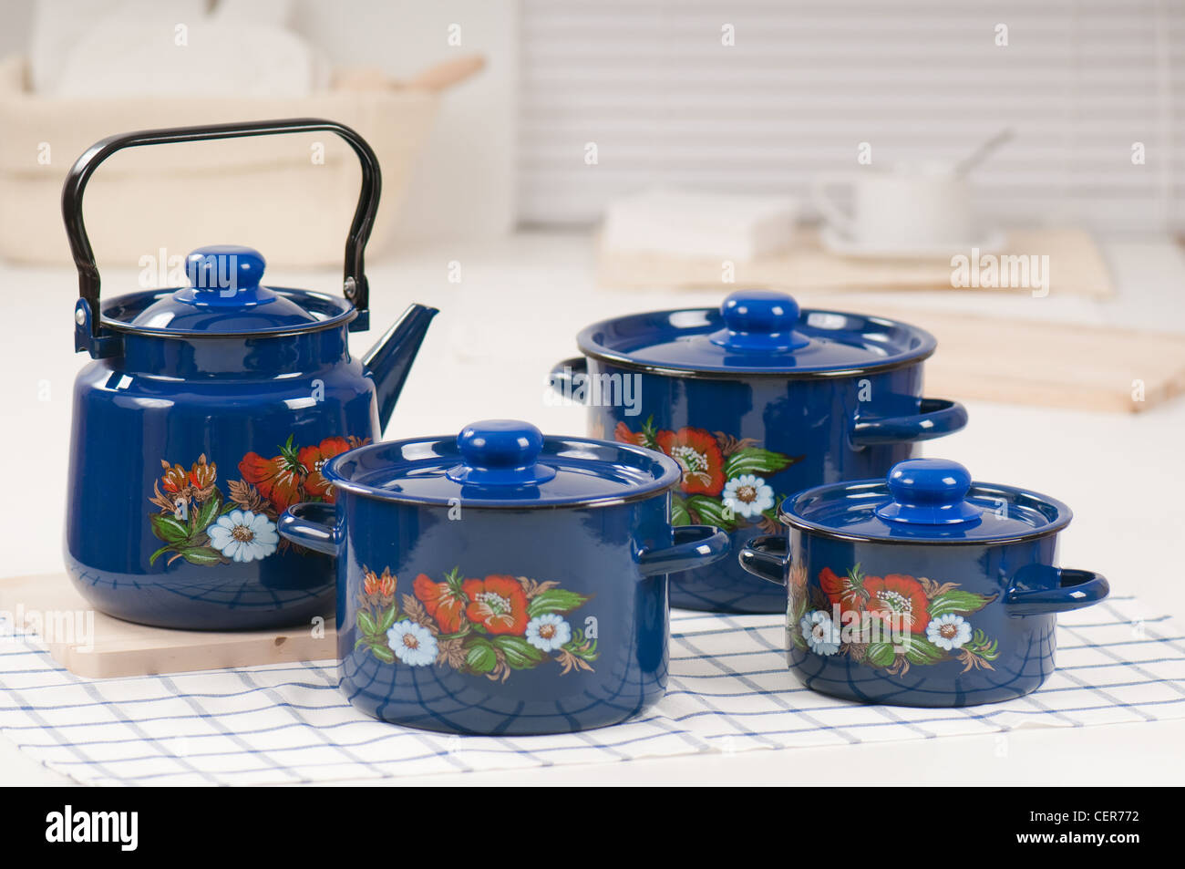 Kitchen utensil set of blue pots and kettle arranged on a table Stock Photo - Alamy