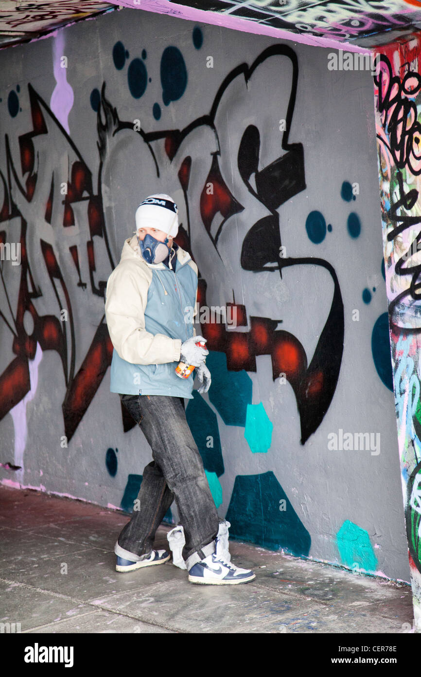 Guy Spray Painting Unrecognizable Man Spraying Paint On Concrete Wall