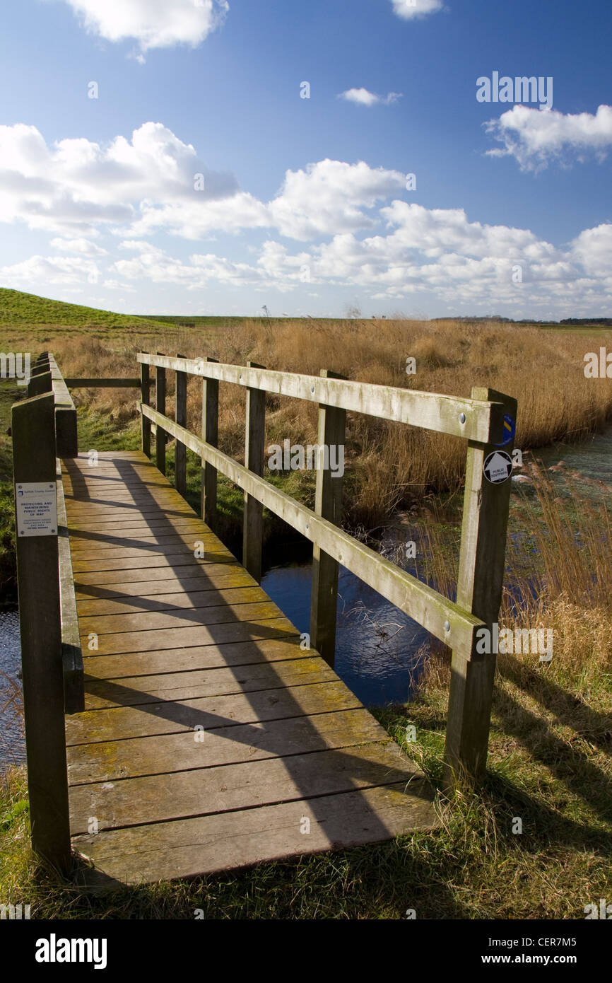 A wooden footbridge takes the footpath over a channel at Chantry ...