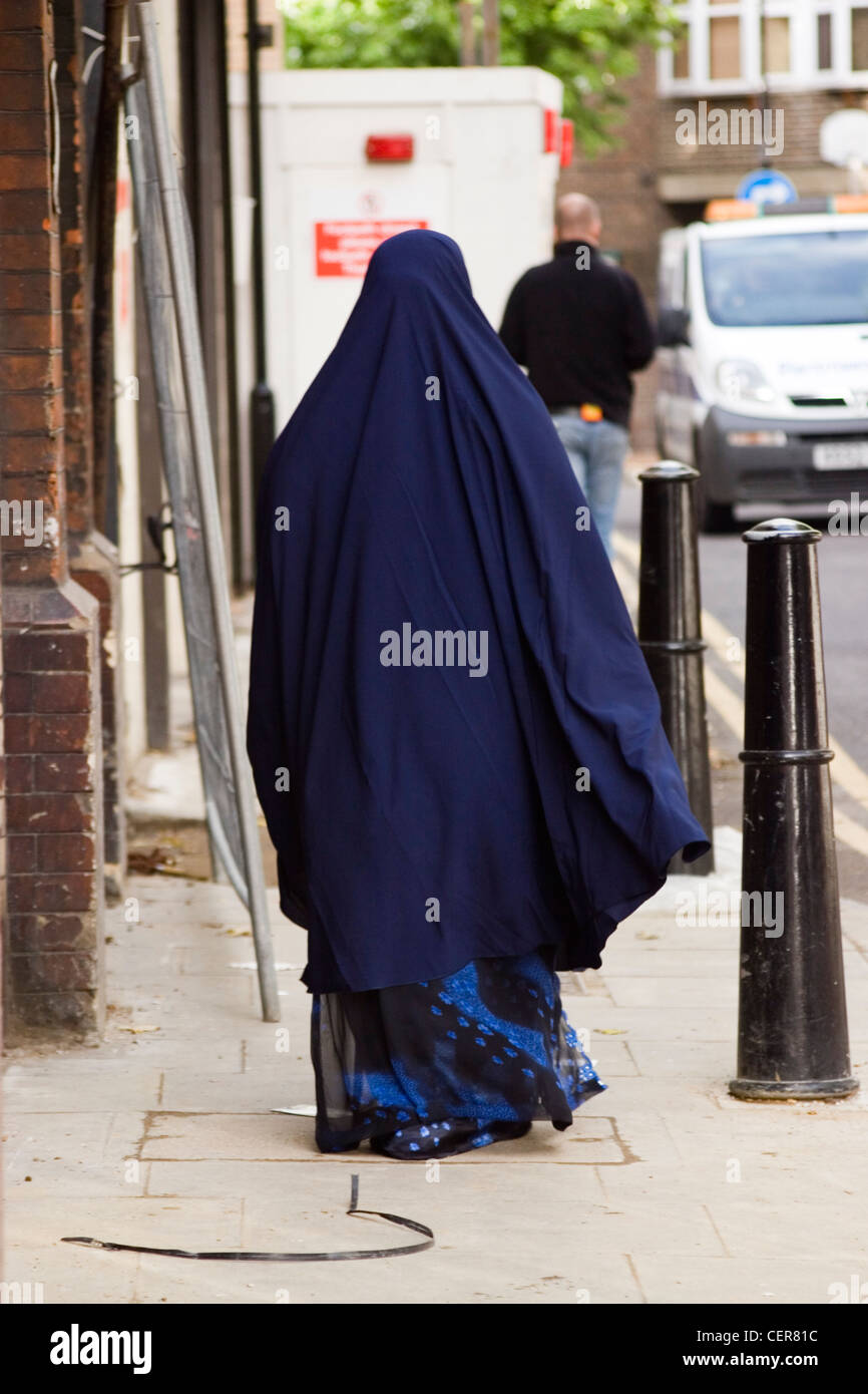 Worshipper going to the mosque in Whitechapel. Mosques originated on ...