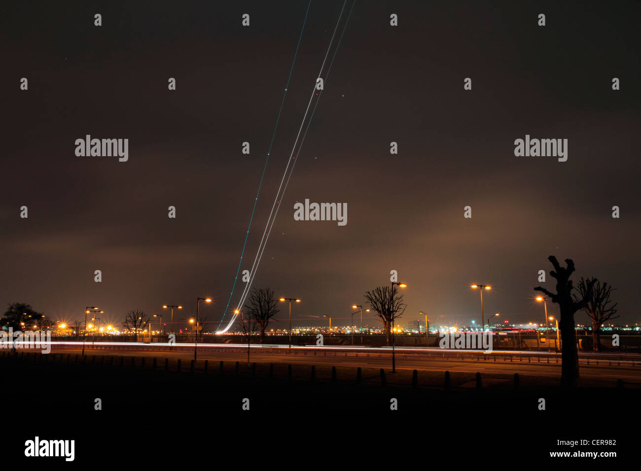 Light trail from an aircraft taking off from London Heathrow airport at ...