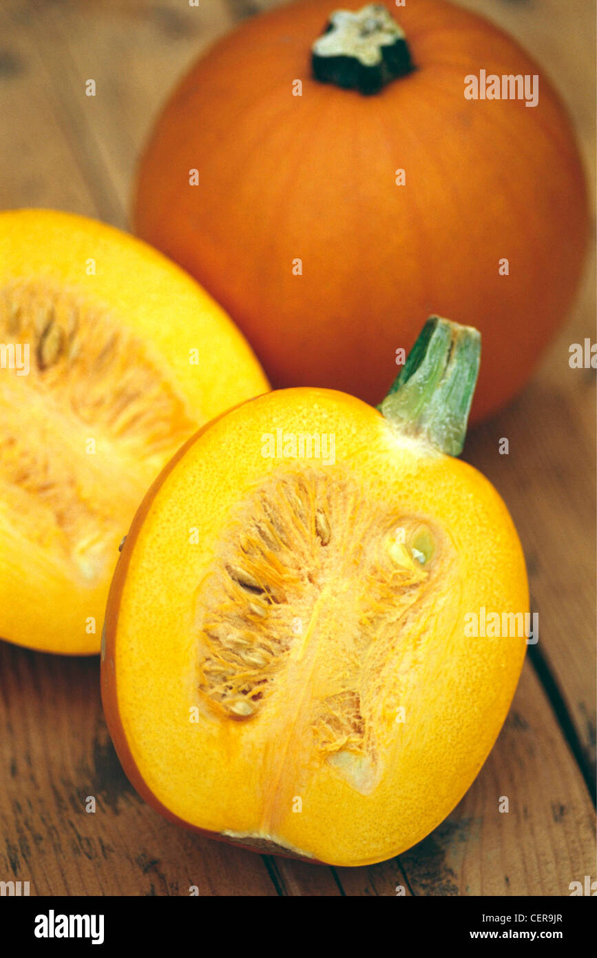 CX100D381 A whole pumpkin and a pumpkin cut in half Stock Photo - Alamy