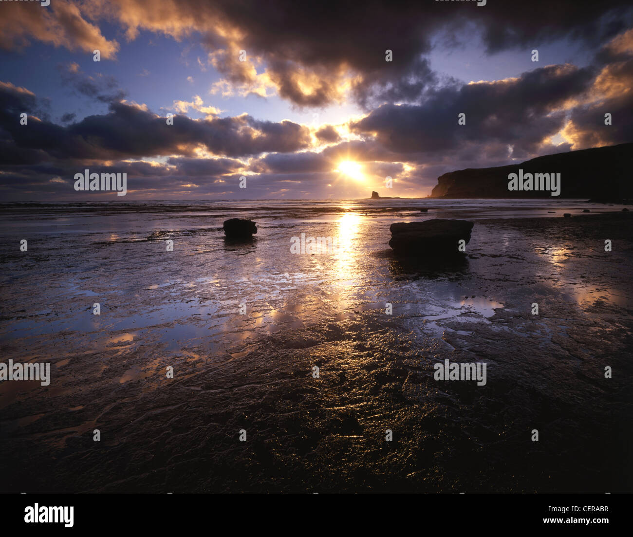 A dramatic sunrise on the rock platform at Saltwick Bay near Whitby ...