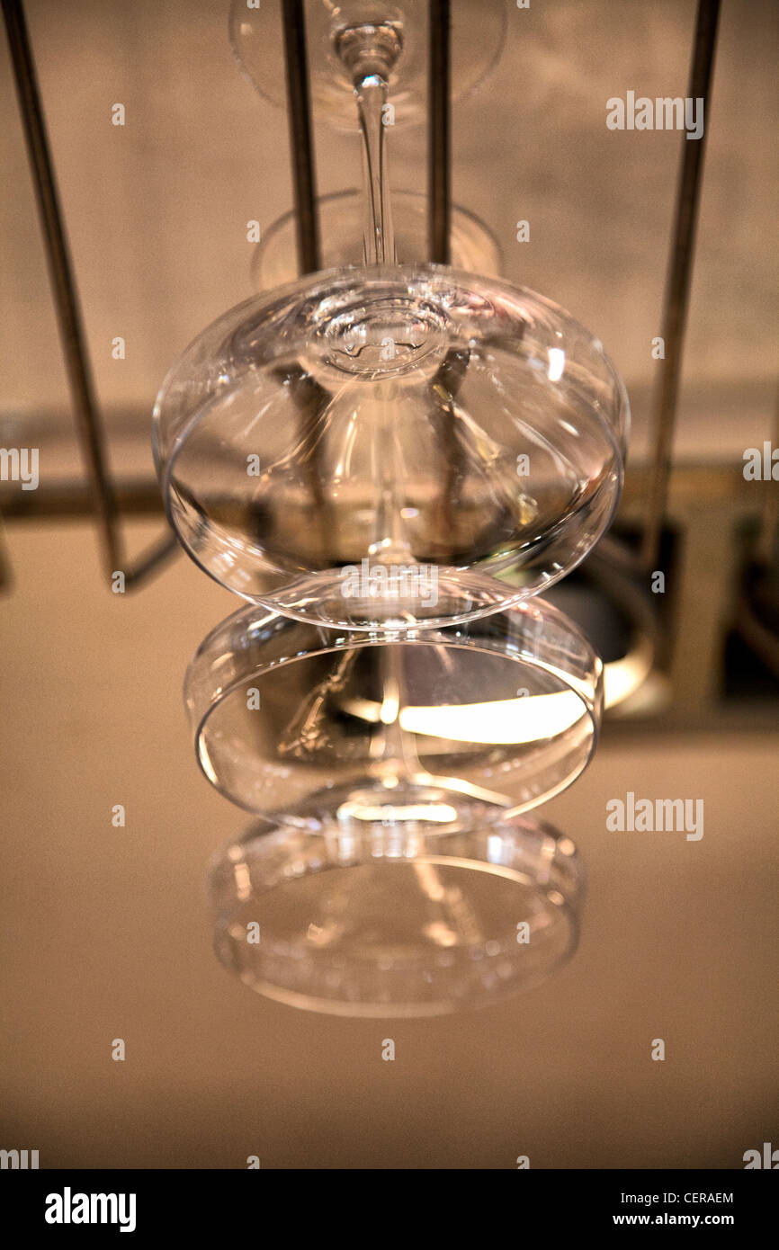 Glasses suspended over bar Stock Photo - Alamy