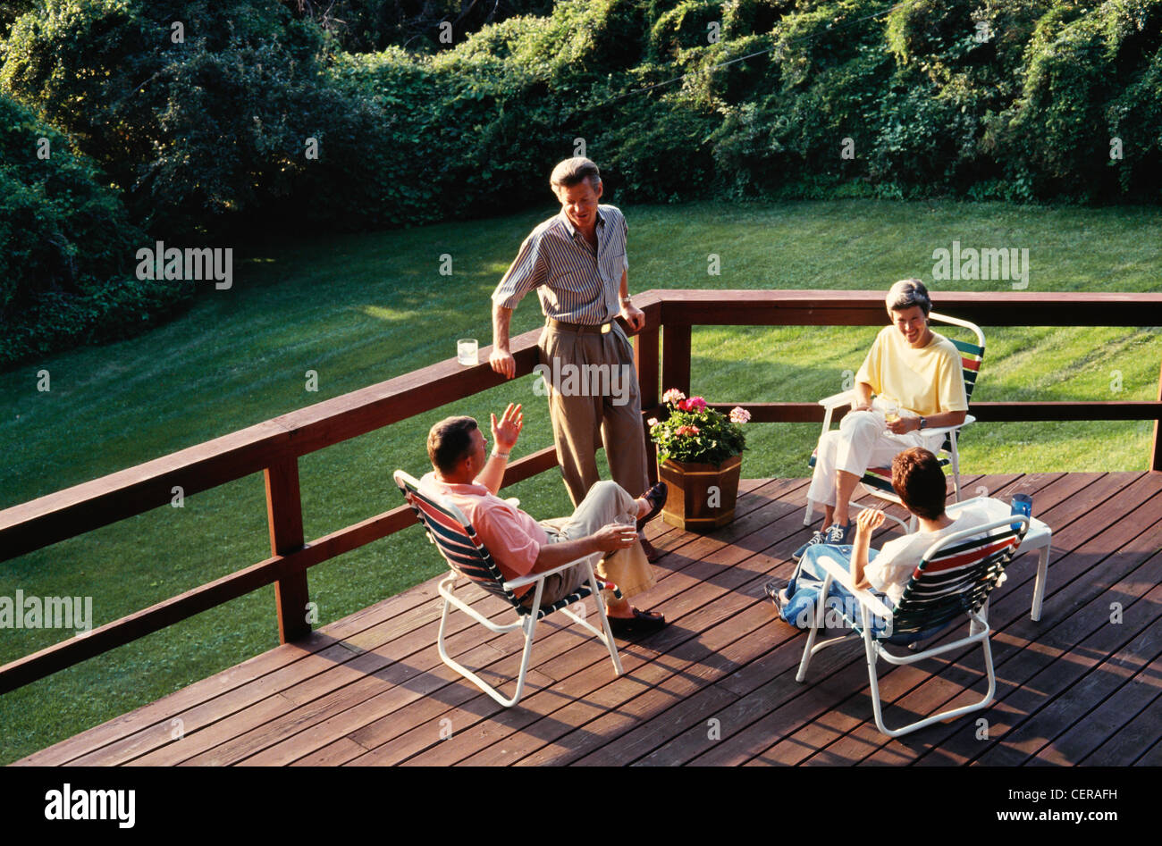 Two Couples Socializing on Suburban Deck Stock Photo - Alamy