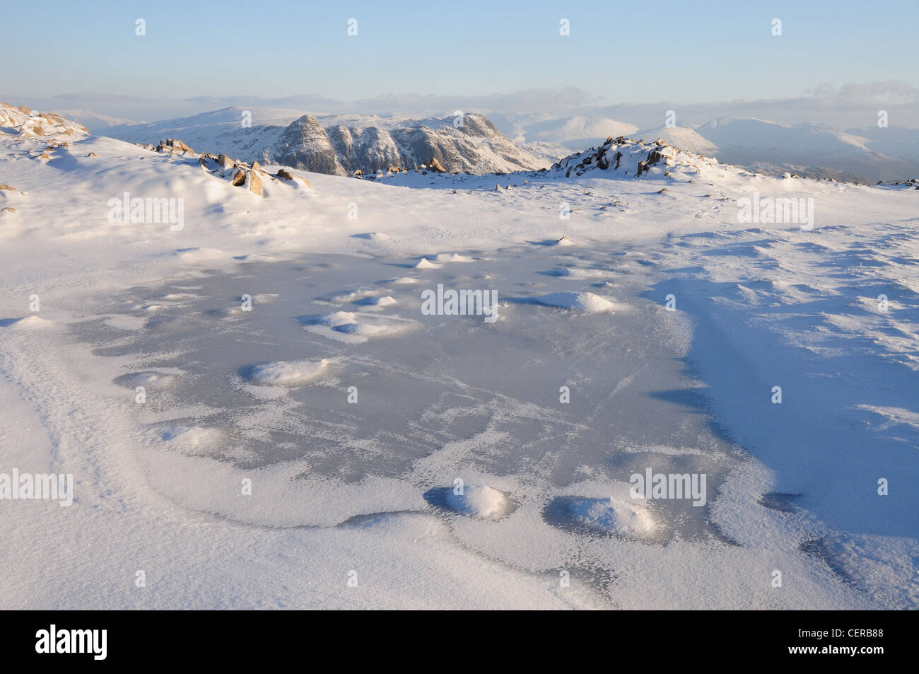Frozen tarn on Great Knott, Crinkle Crags, with the Langdale Pikes in ...