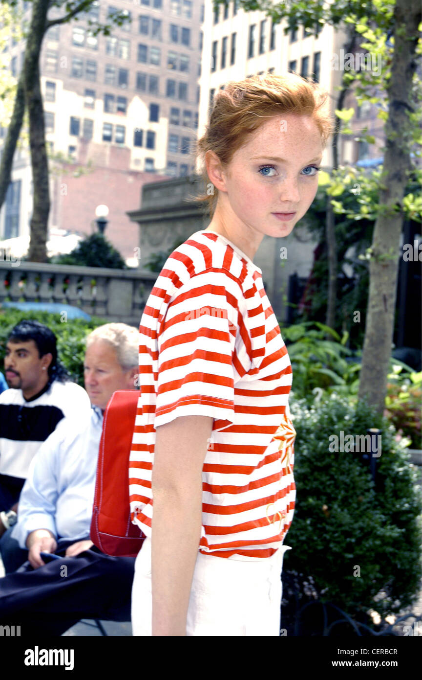 British model Lily Cole hair pulled back wearing red and white ...