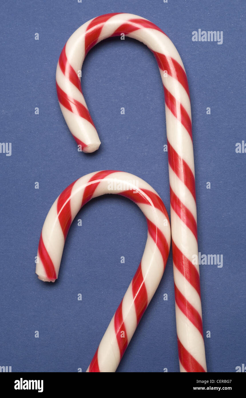Two striped red and white candy sticks, lying vertical side by side ...