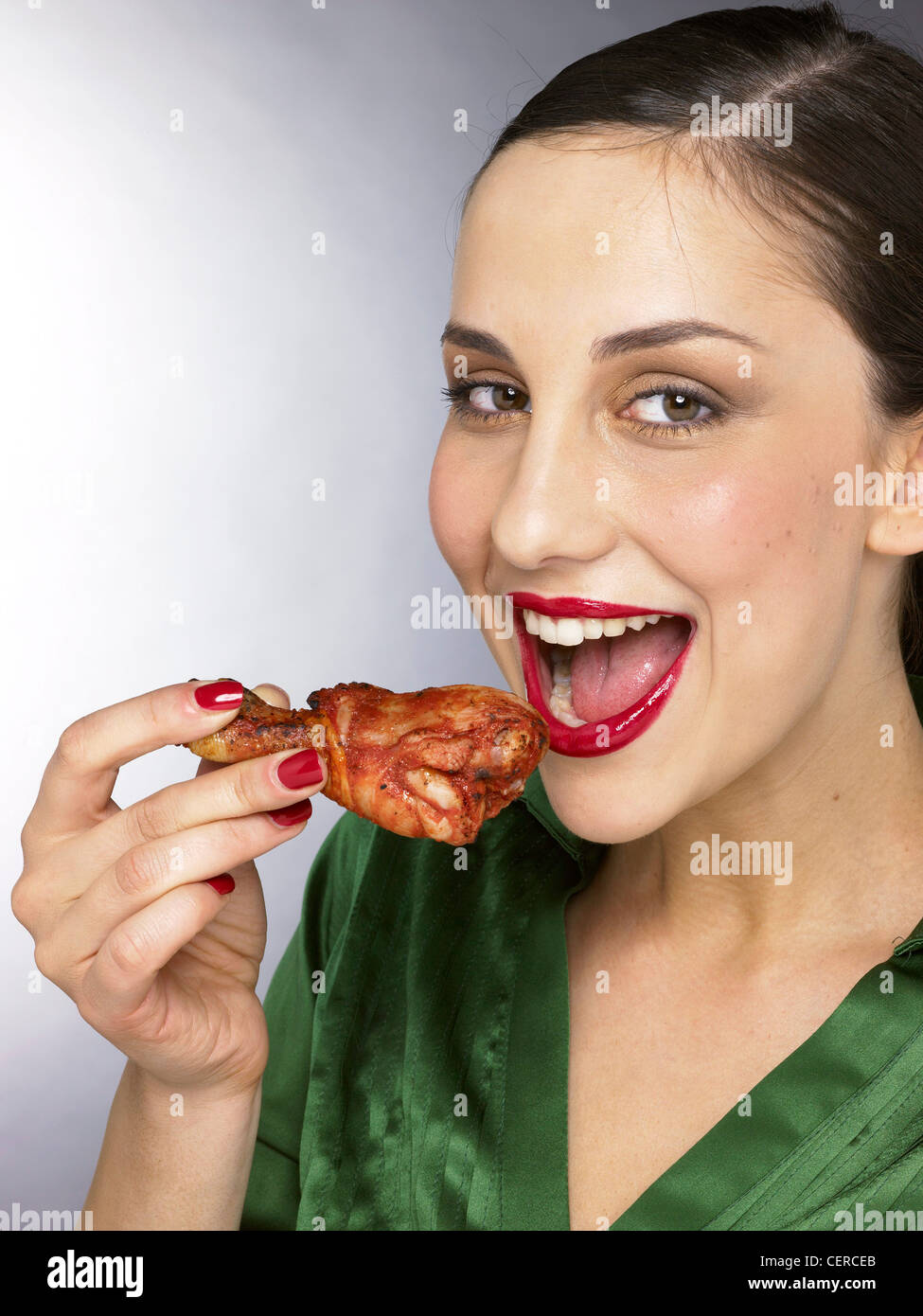 Glamorous woman eating chicken hi-res stock photography and images - Alamy