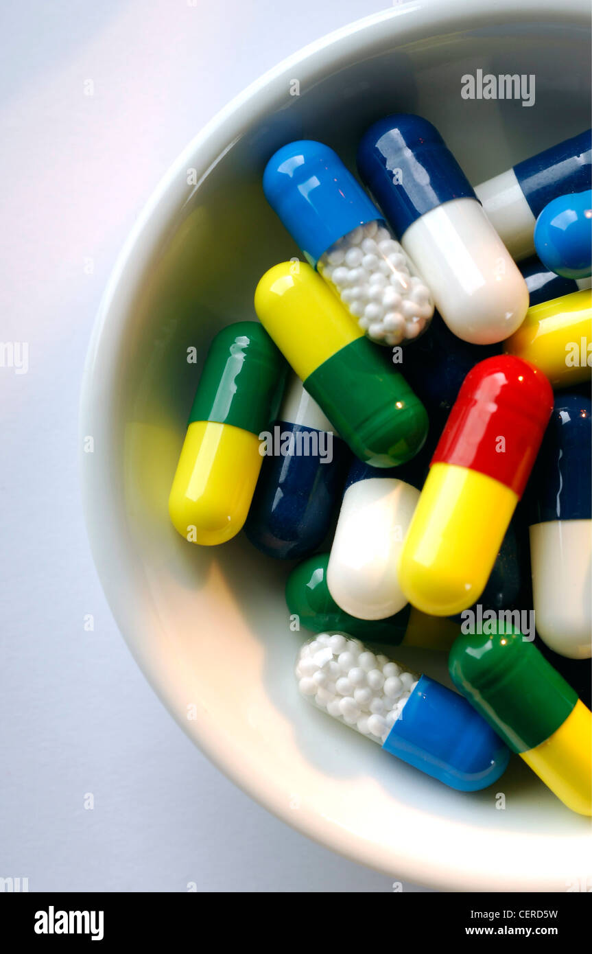 Aerial view of assorted multicoloured capsules in a white bowl Stock ...