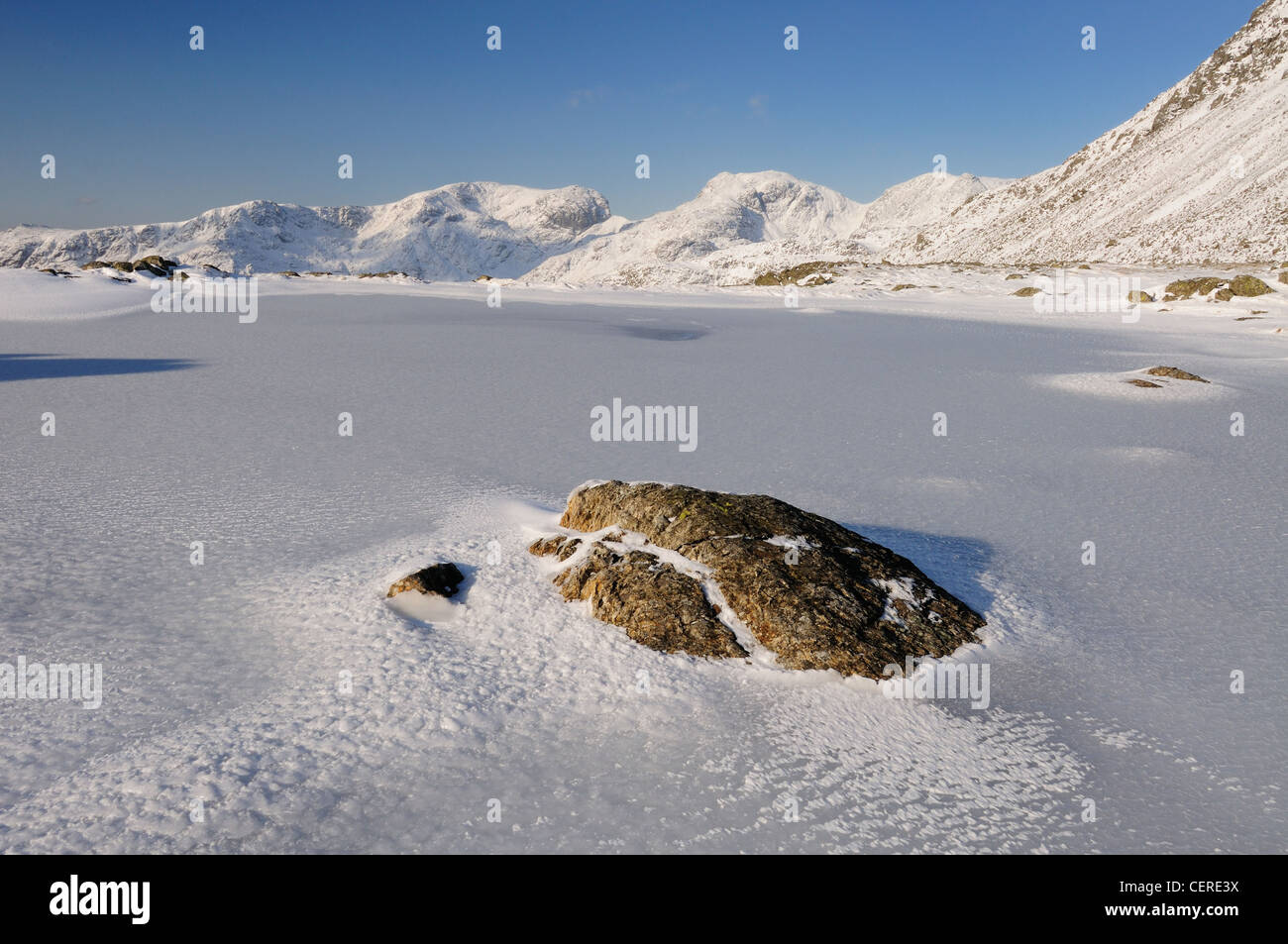 Frozen mountain tarn in the English Lake District, with Scafell and ...