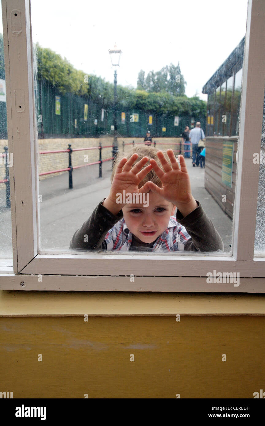 Scared boy looking outside window hi-res stock photography and images ...