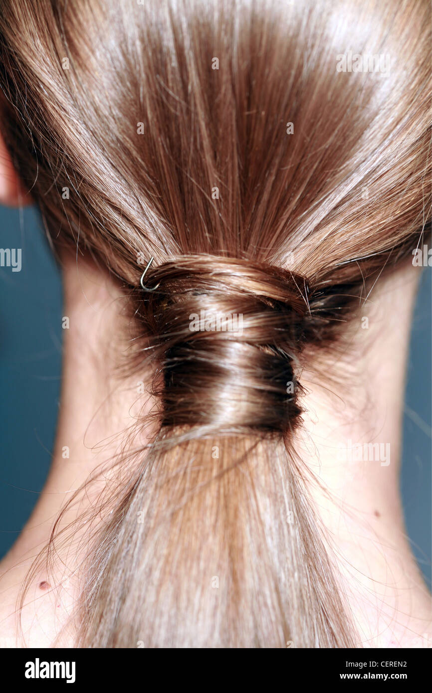 Cropped head back view of female with shiny brunette low ponytail Stock ...