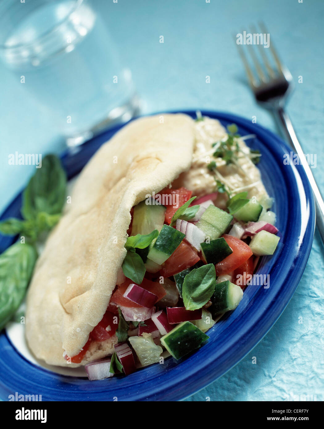 White pitta bread with hummus, cress, cucumber, red onion, basil ...
