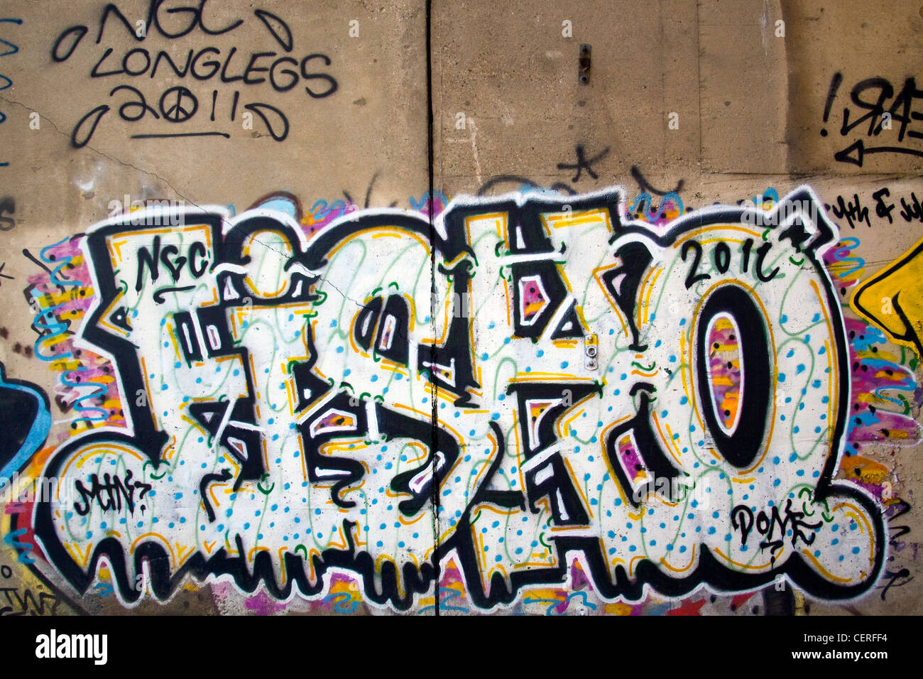 Graffiti art on a concert wall of a trashy abandoned street car road ...